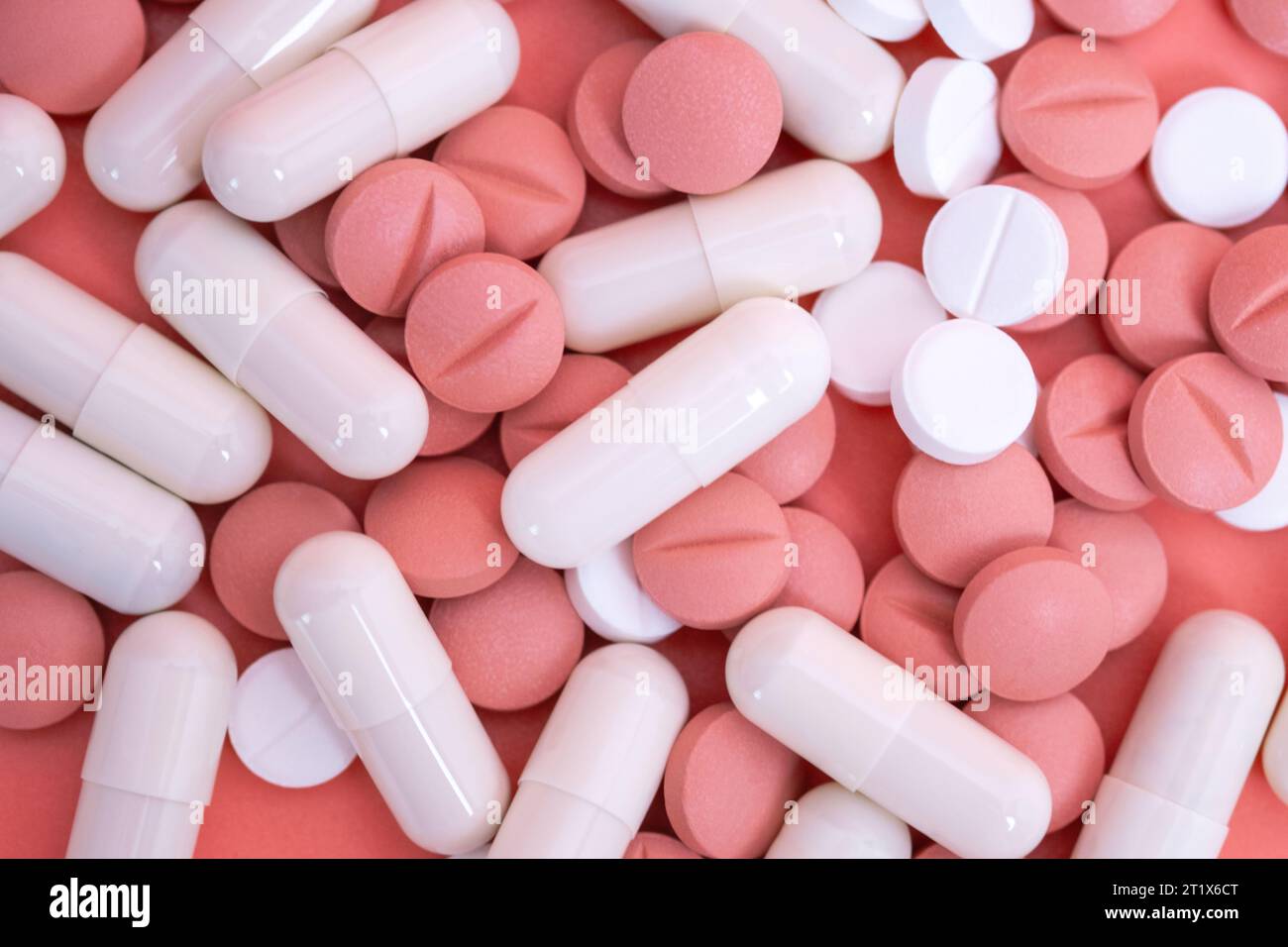 Many pink and white pills and capsules. Medical treatment with medicine ...