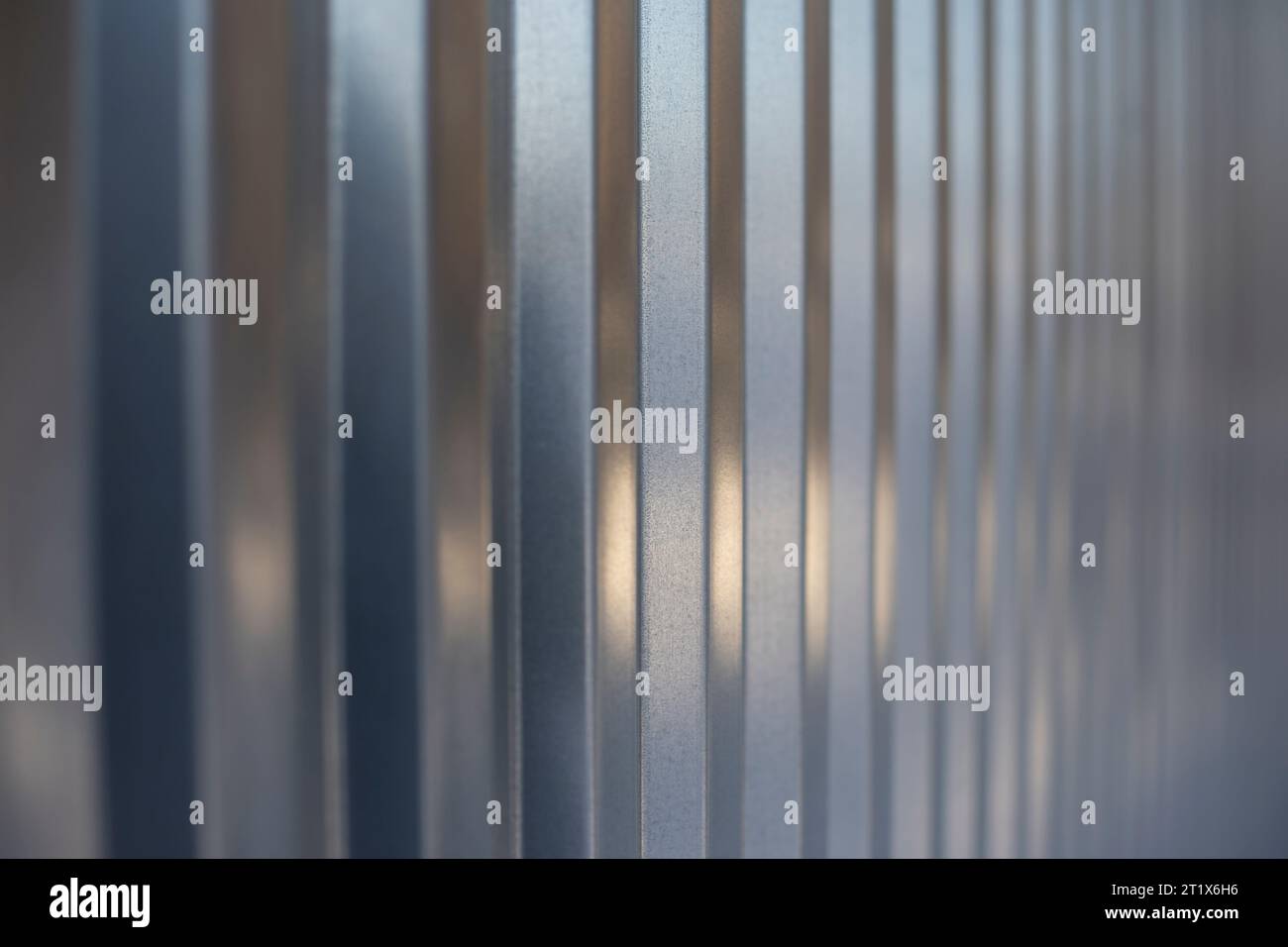 Steel fence. Metal profile sheet. Ribbed surface of the fence. Silver ...