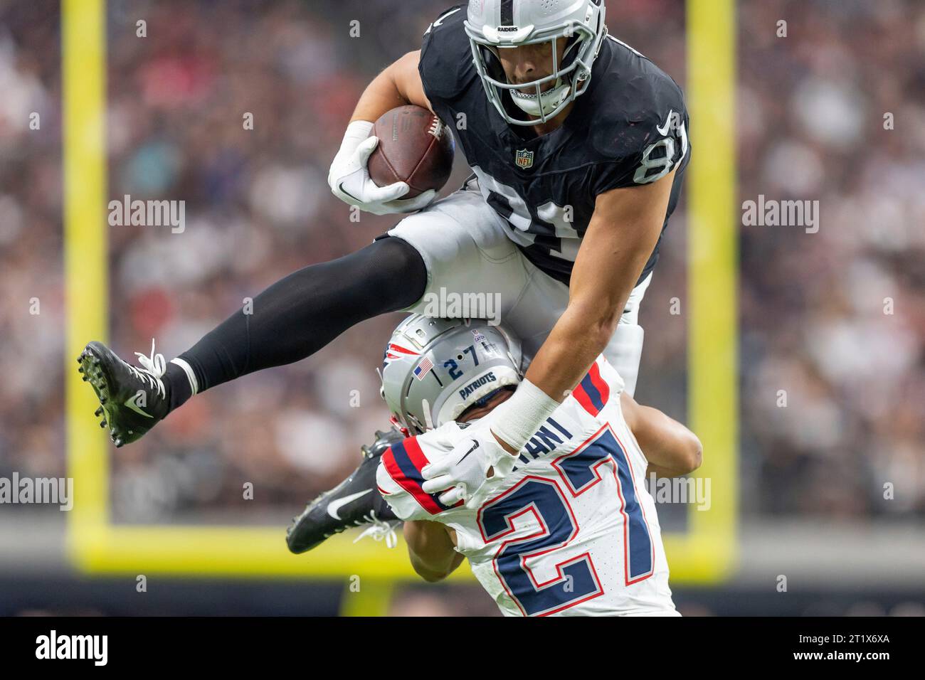 Las Vegas Raiders tight end Austin Hooper (81) leaps over New England ...