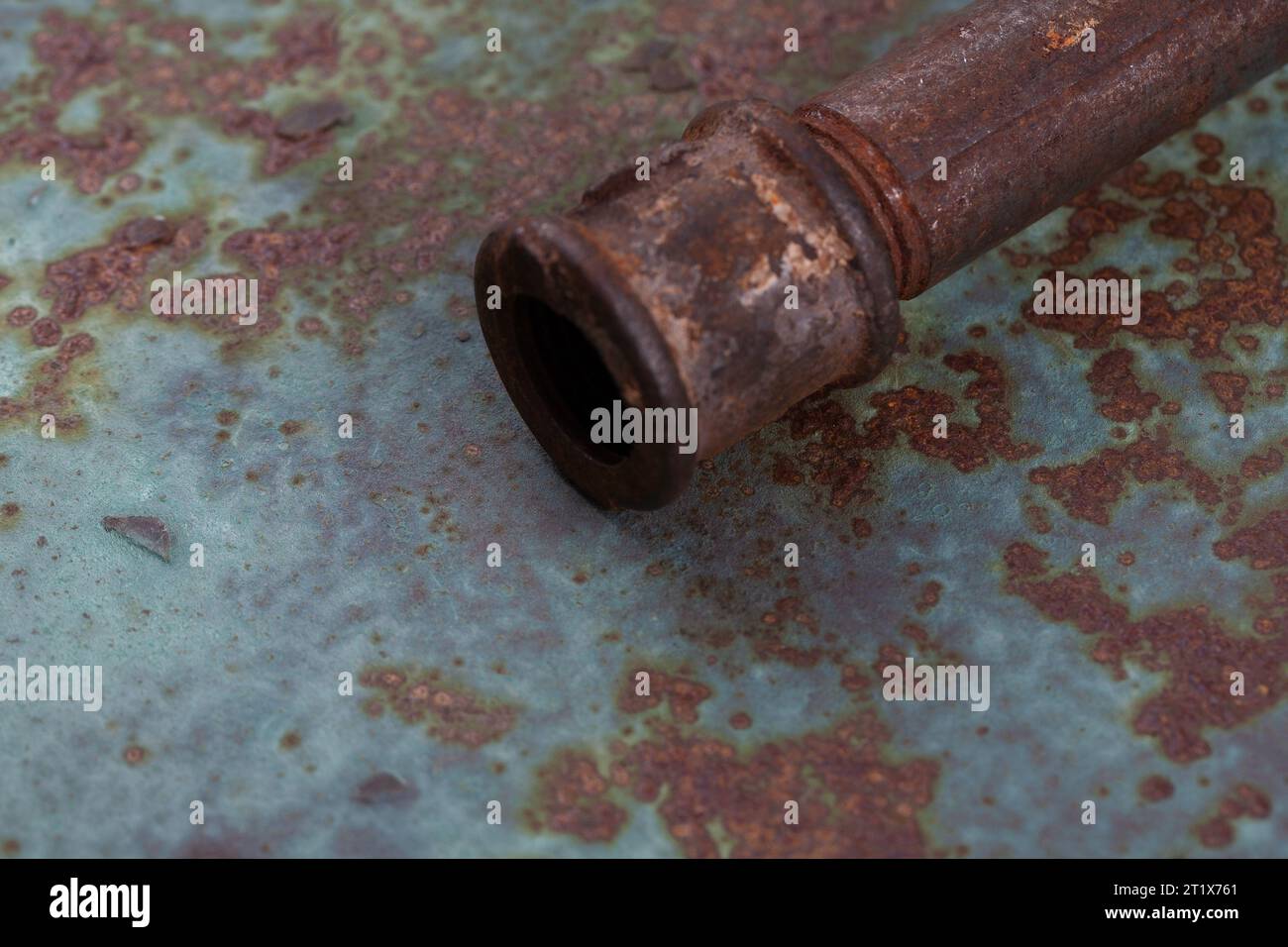 Rusty plumb tube on rusty metal wall background Stock Photo - Alamy