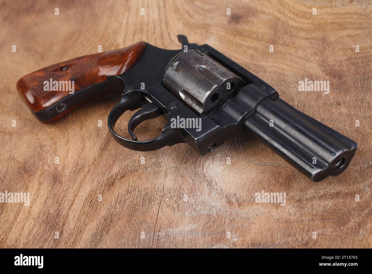 Revolver on wooden table background Stock Photo - Alamy