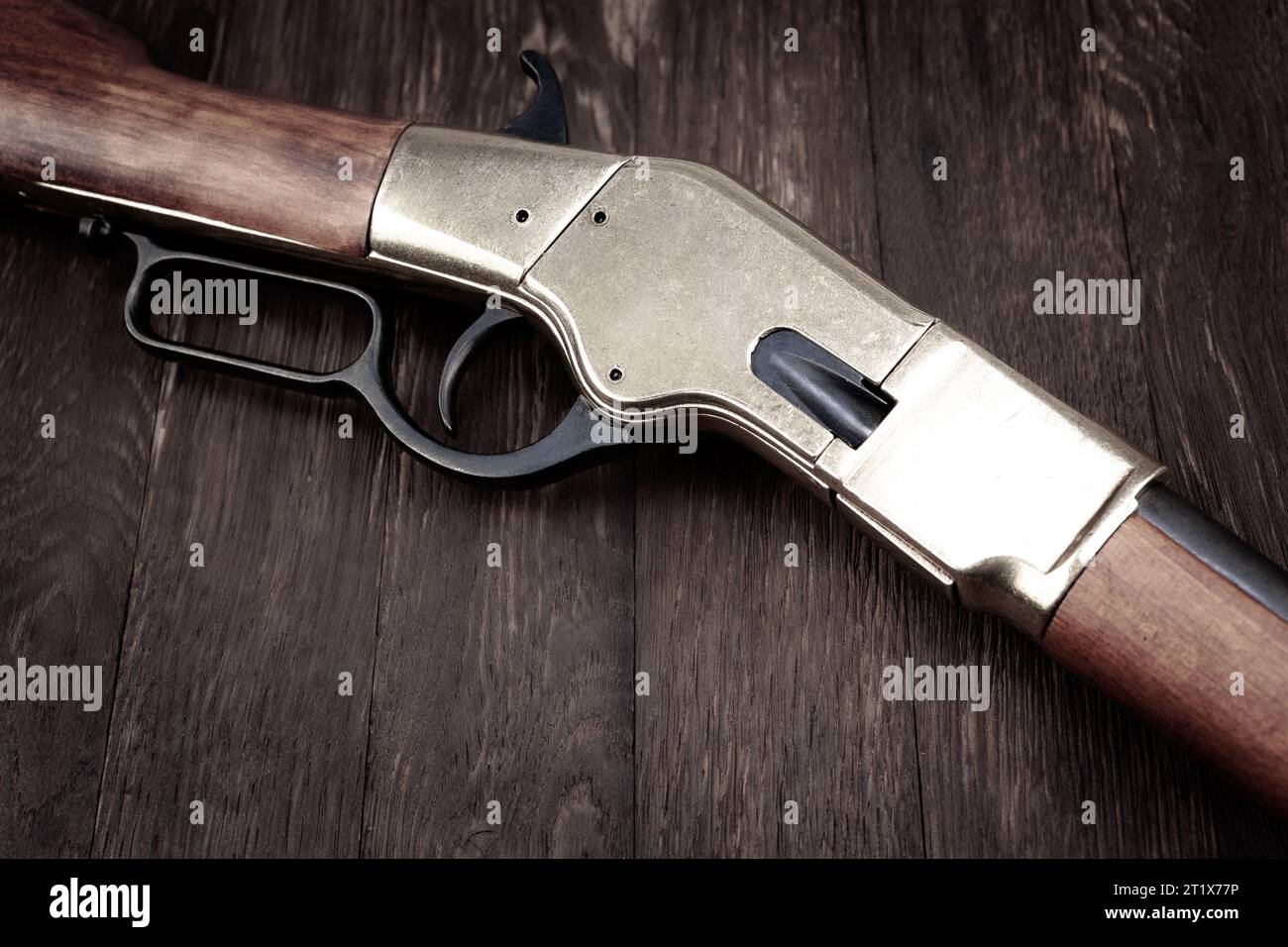 Old west gun. Lever-action repeating rifle with ammunition on wooden ...