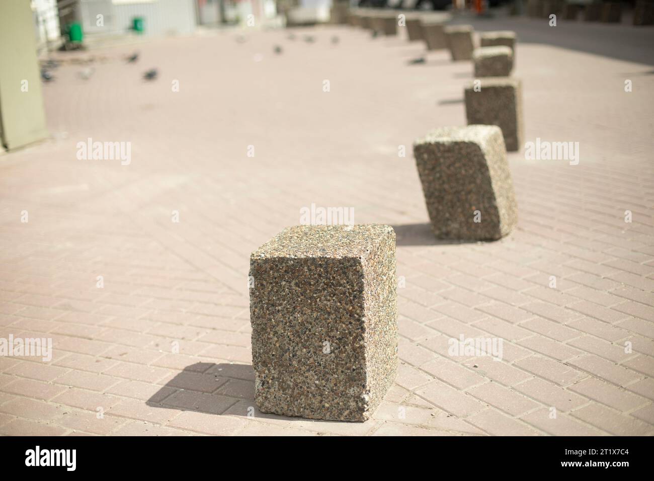 Parking poles. Fence from cars on pavement. Stone obstacles in city ...