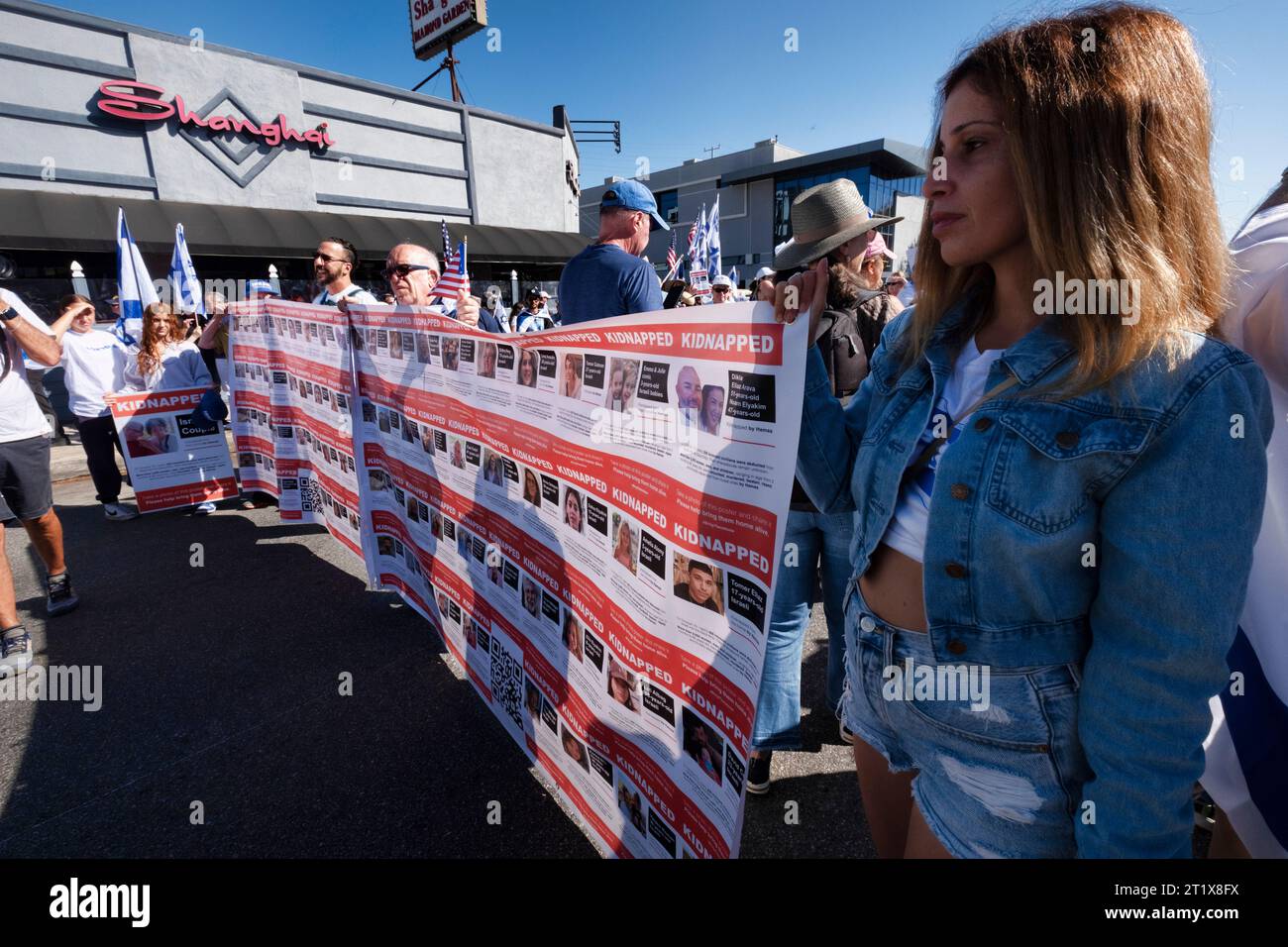 Supporters for Israel carry a banner with photos of kidnapped Israeli ...