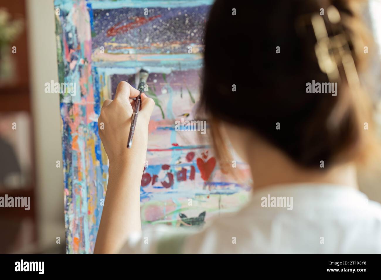 Close up Asian Woman painting on canvas during special skills class ...