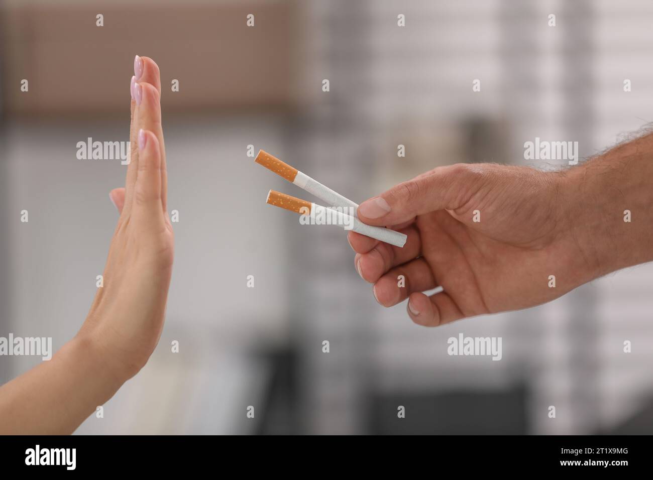 Stop smoking concept. Woman refusing cigarettes on blurred background ...