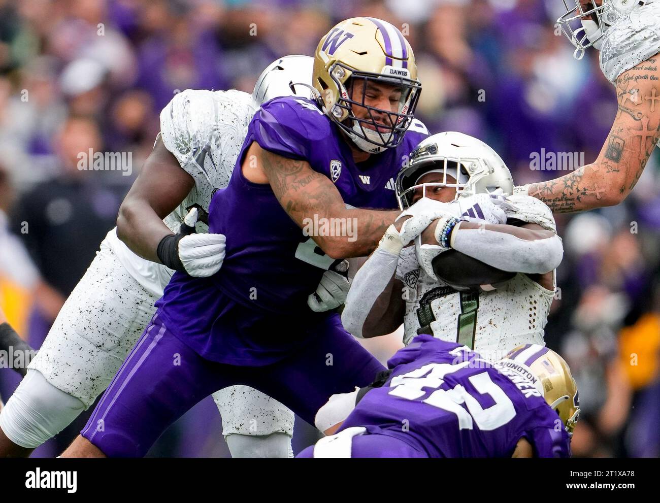 Oregon running back Bucky Irving is tackled by Washington defensive end ...