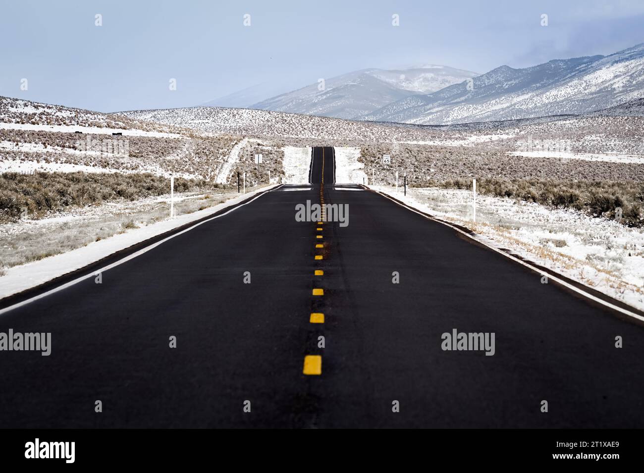 A scenic view of an empty asphalt road in a barren desert Stock Photo ...