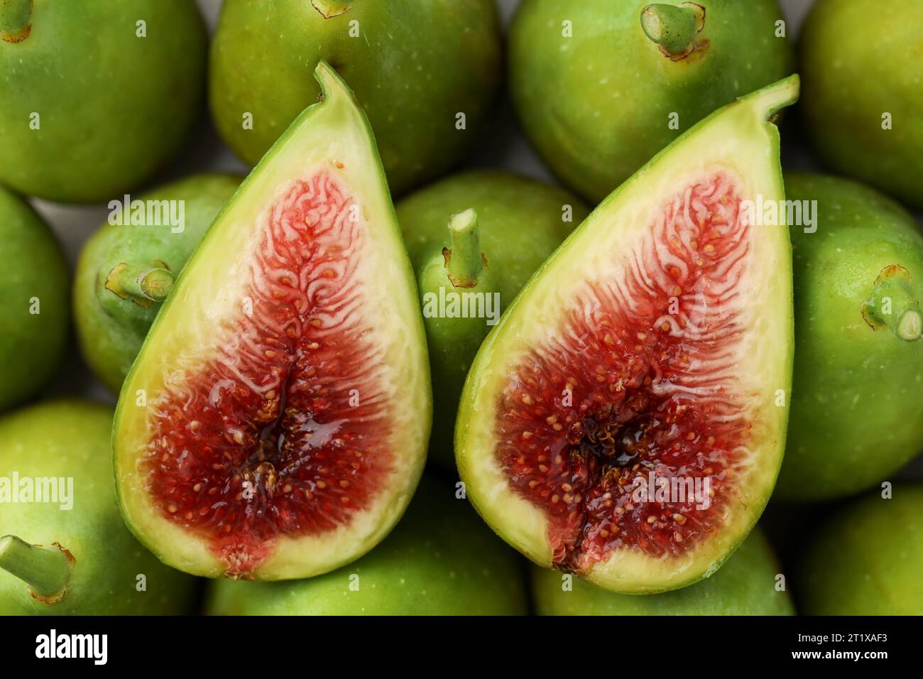 Cut and whole fresh green figs as background, top view Stock Photo - Alamy