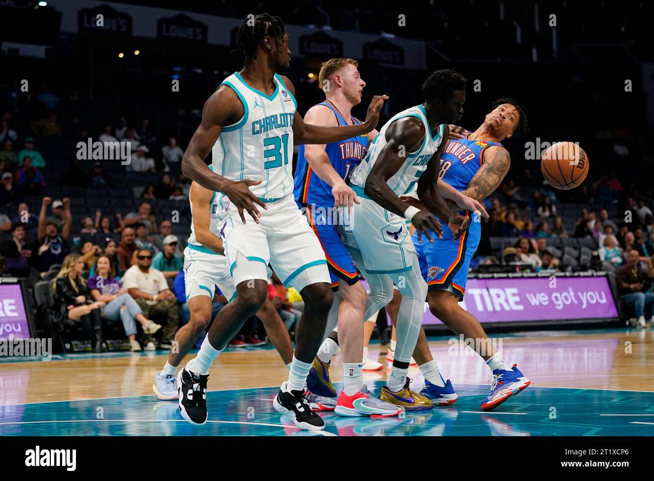 Players battle for a loose ball in the second half of a preseason NBA ...