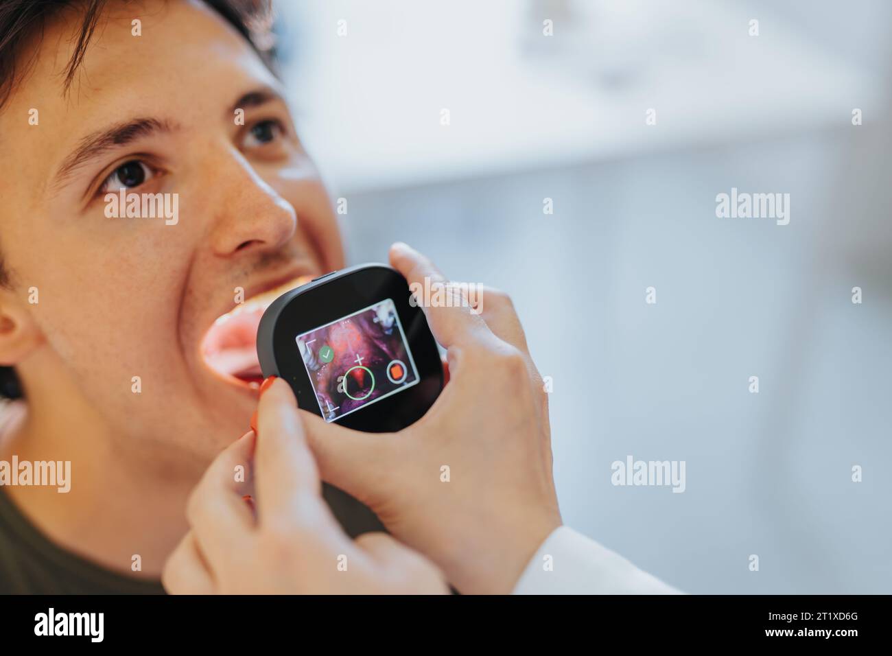 Doctor checking a patient throat using video laryngoscope. Close up ...