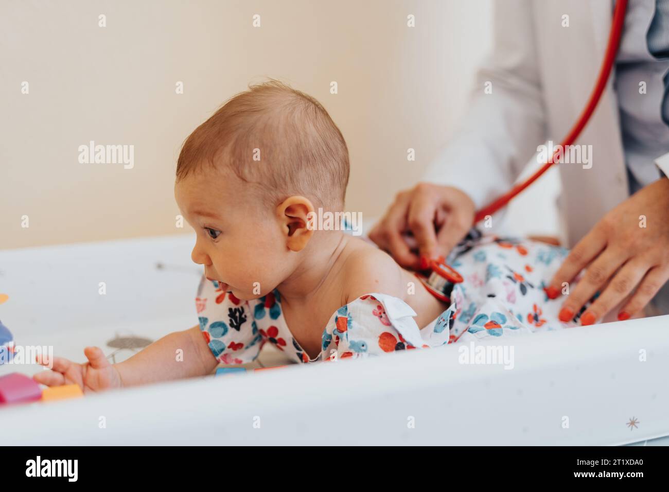 Caring Doctor Conducts Checkup on Adorable Baby Patient Using ...