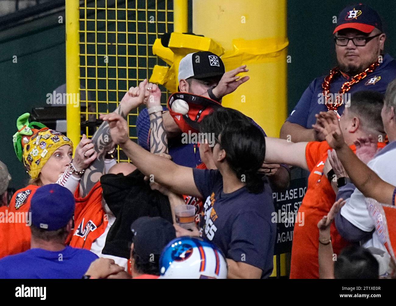 Houston, United States. 15th Oct, 2023. A fan catches a Texas Rangers ...