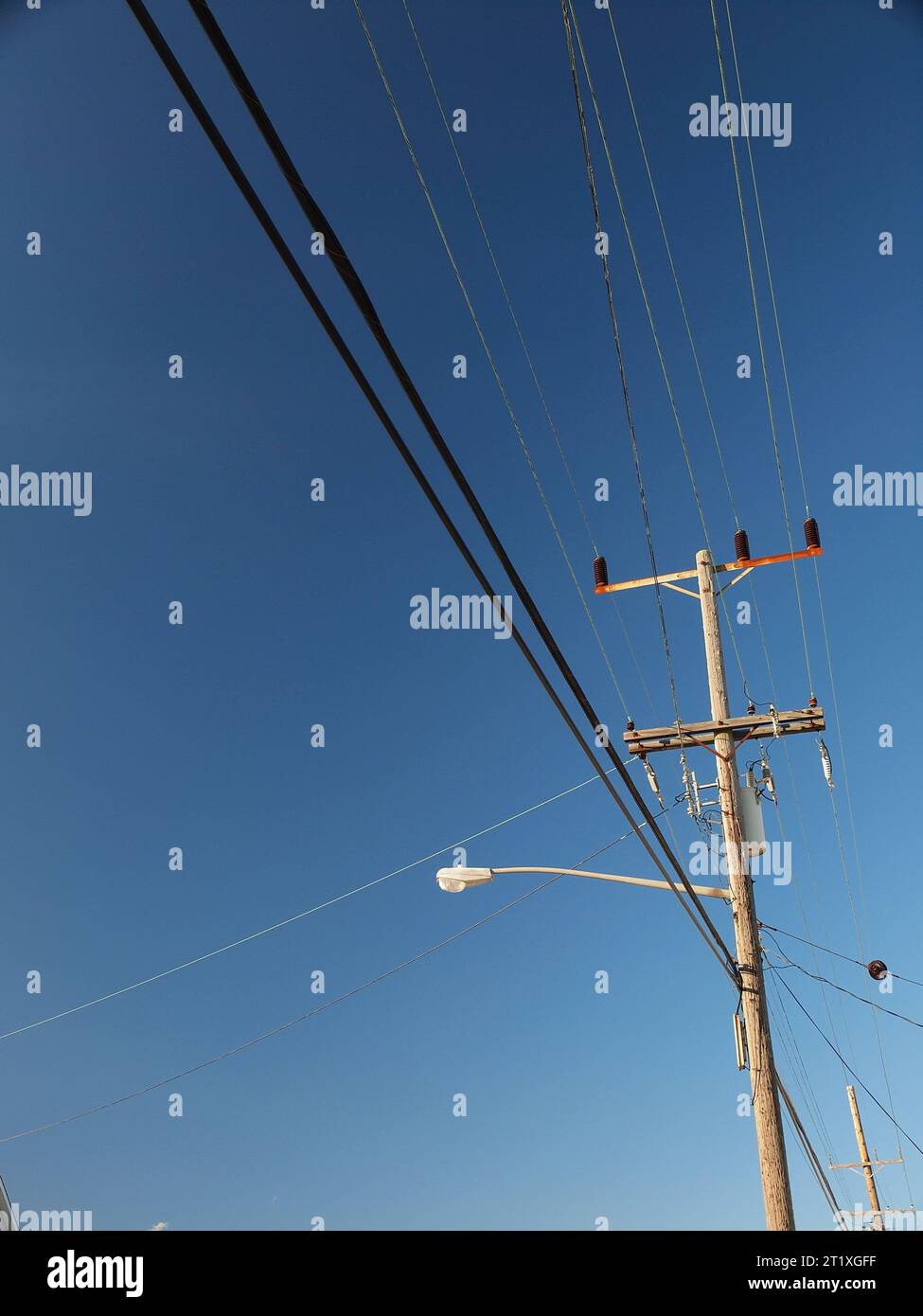 Tall utility pole with electric, cable and telephone facilities with a ...
