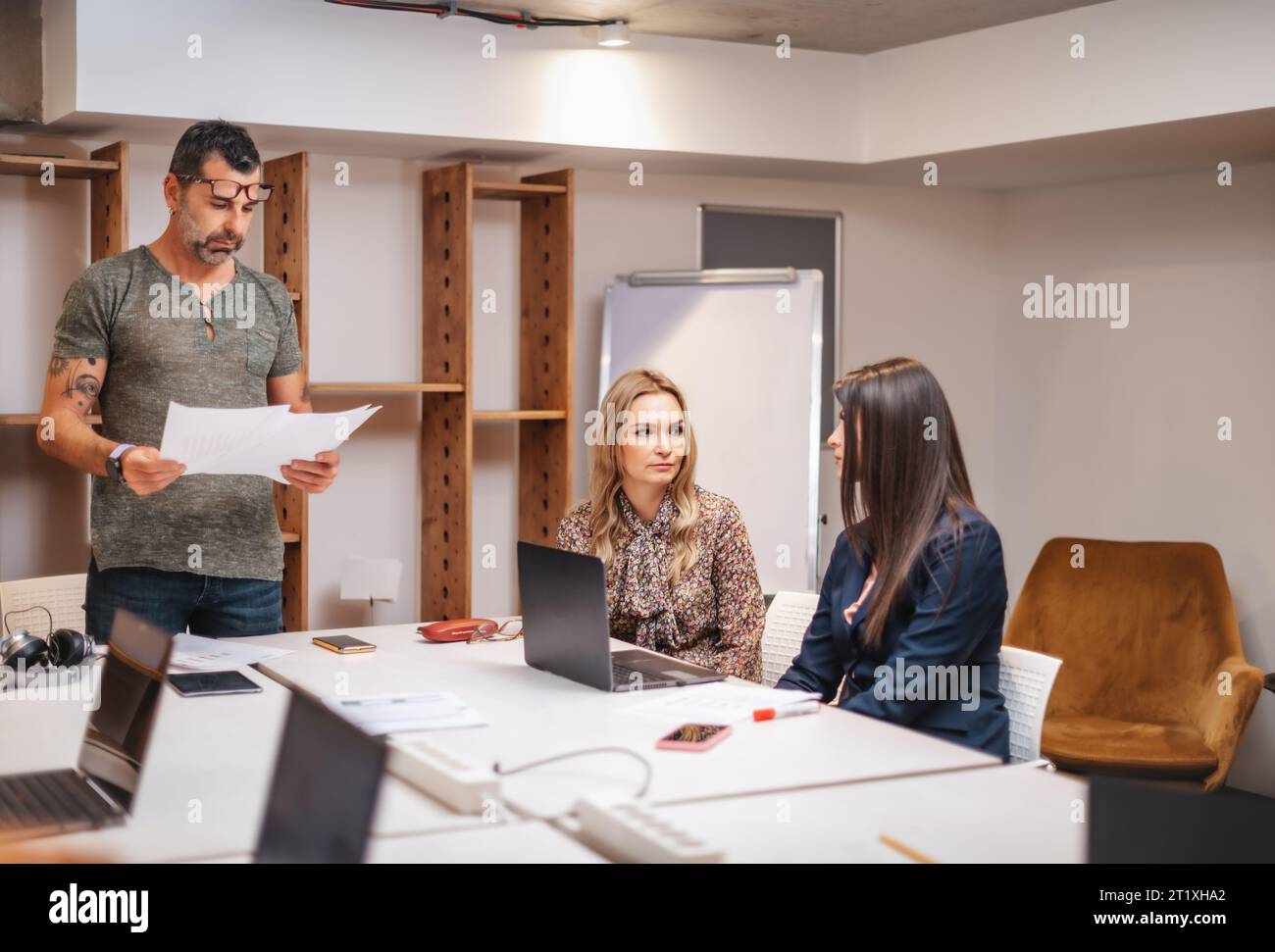 Businessman Reading Project Instructions Women Team Leaders Setting Up