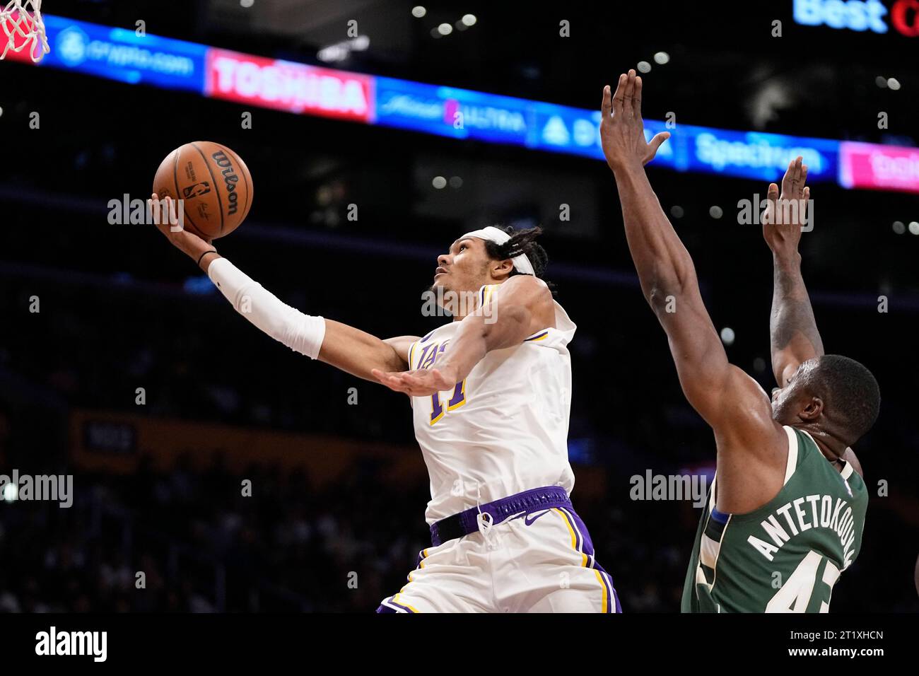 Los Angeles Lakers forward Alex Fudge, left, shoots as Milwaukee Bucks ...