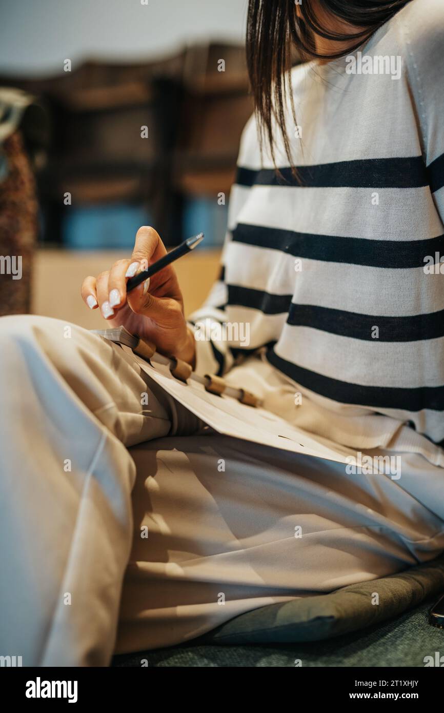 Female employee taking notes during business lecture at work. Workplace ...