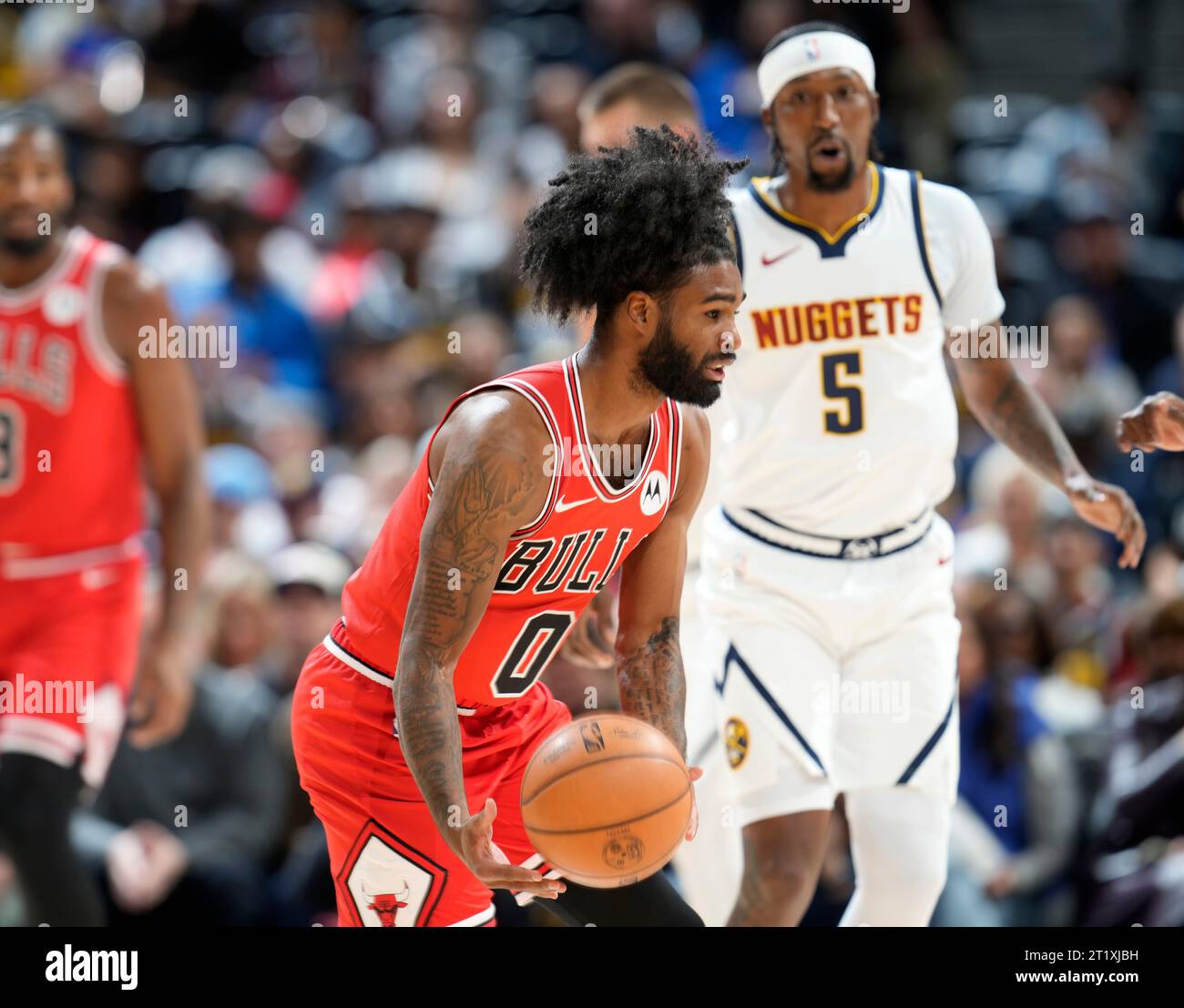 Chicago Bulls guard Coby White, front, looks to pass the ball as Denver ...