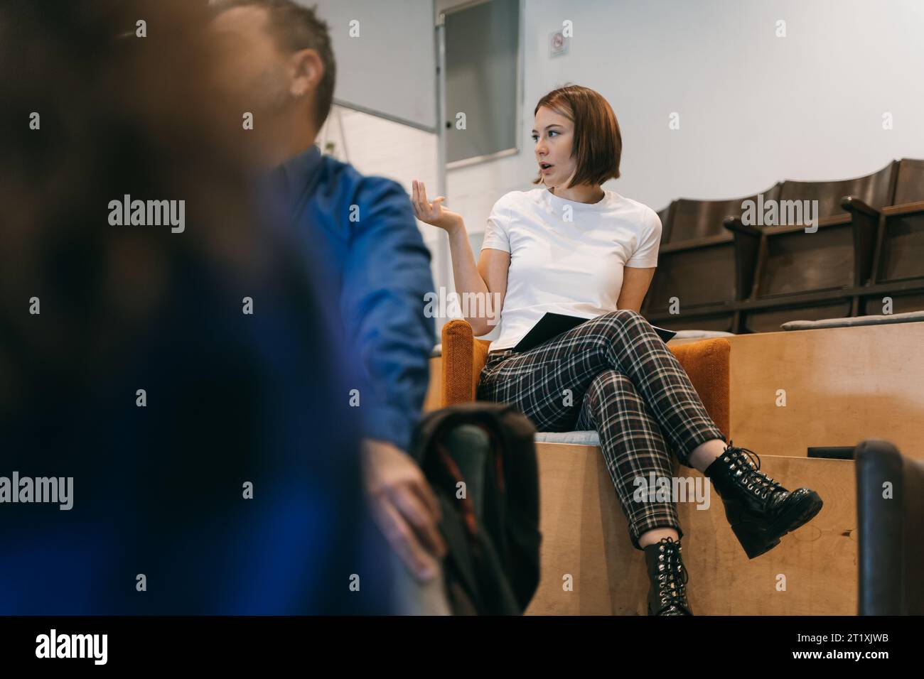 Confused business girl confronting her colleague during presentation at ...