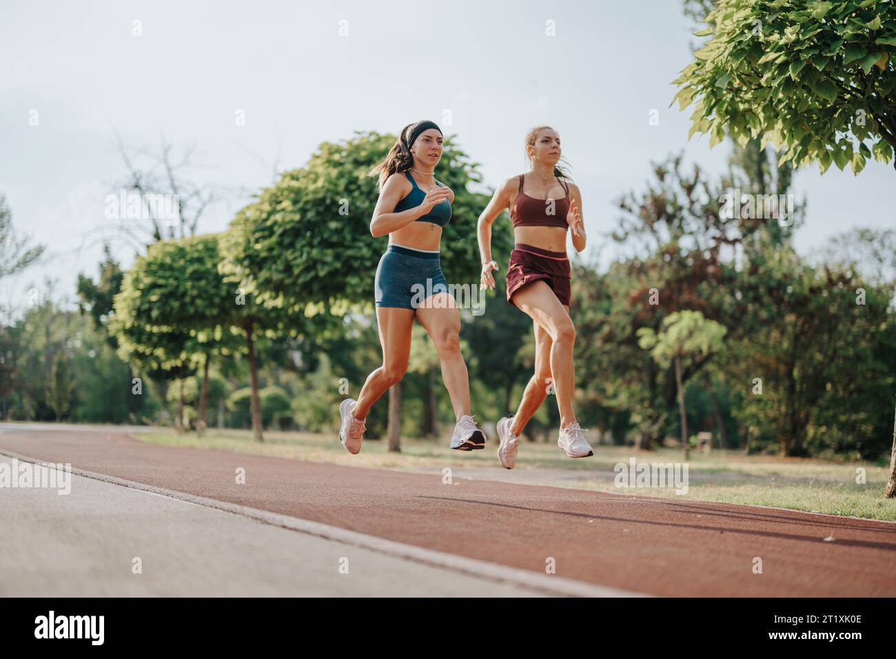 Athletic females jogging outdoors in nature, demonstrating fitness and ...