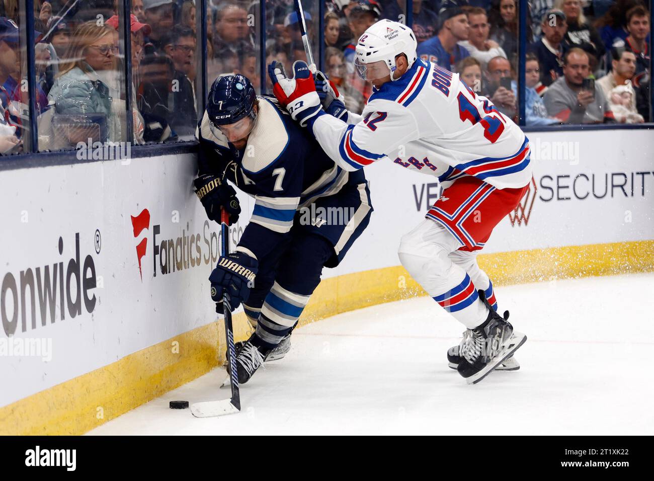 Columbus Blue Jackets forward Sean Kuraly, left, works for the puck in ...