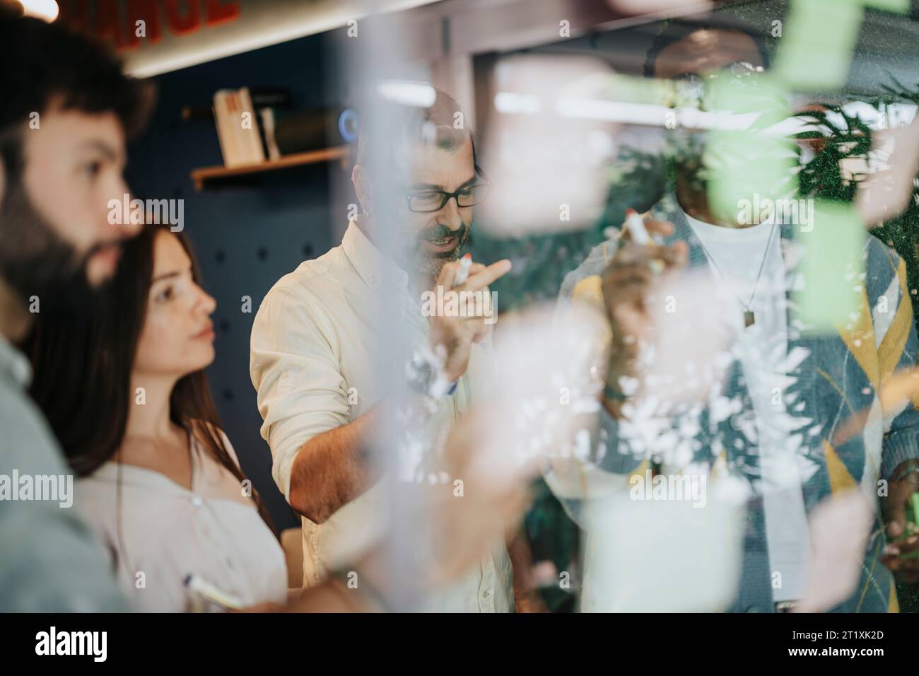 Business team write ideas on sticky notes, sharing knowledge and ...