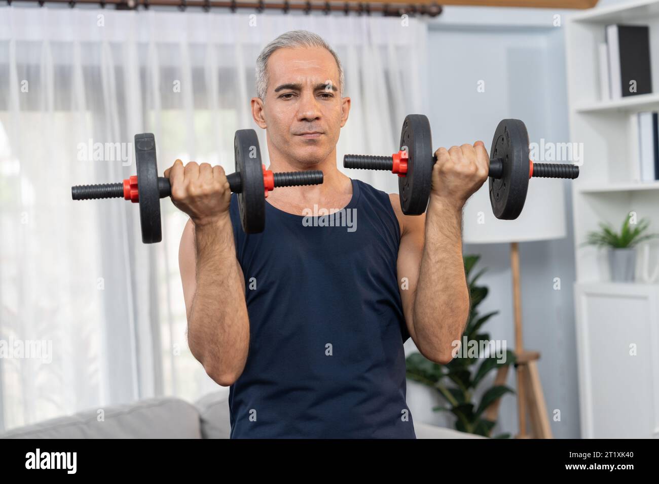 Athletic and sporty senior man engaging in body workout routine with ...