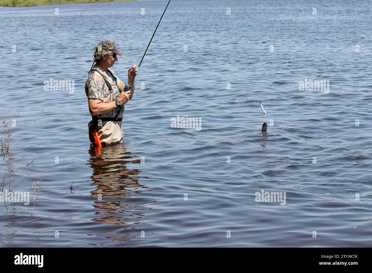 Fishing. One of a series of photos of fishermen catching northern pike ...