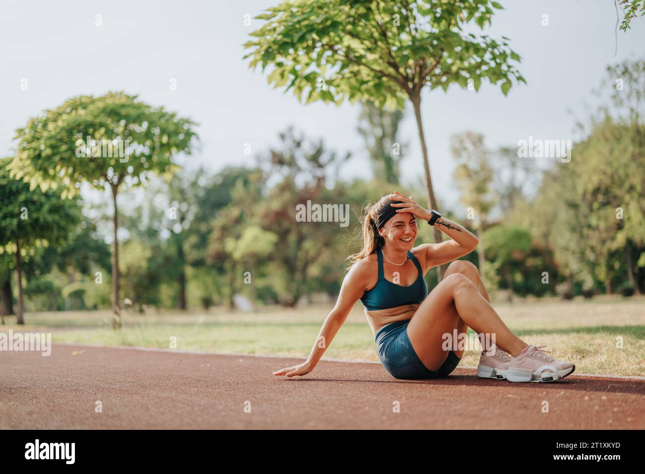 The girl is holding her forehead and laughing after she fell and ...
