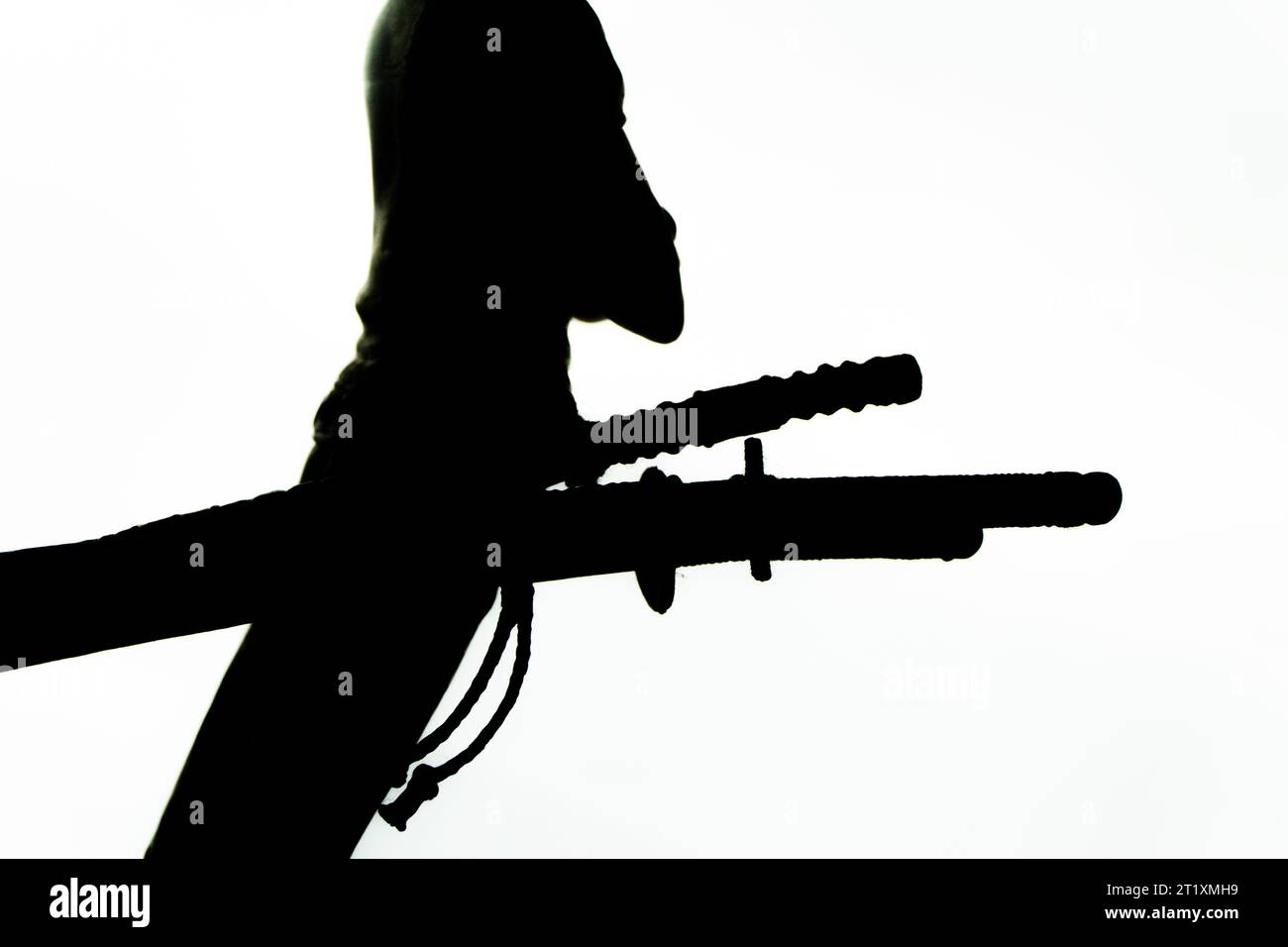 Silhouette of a male action figure using three swords at his waist ...