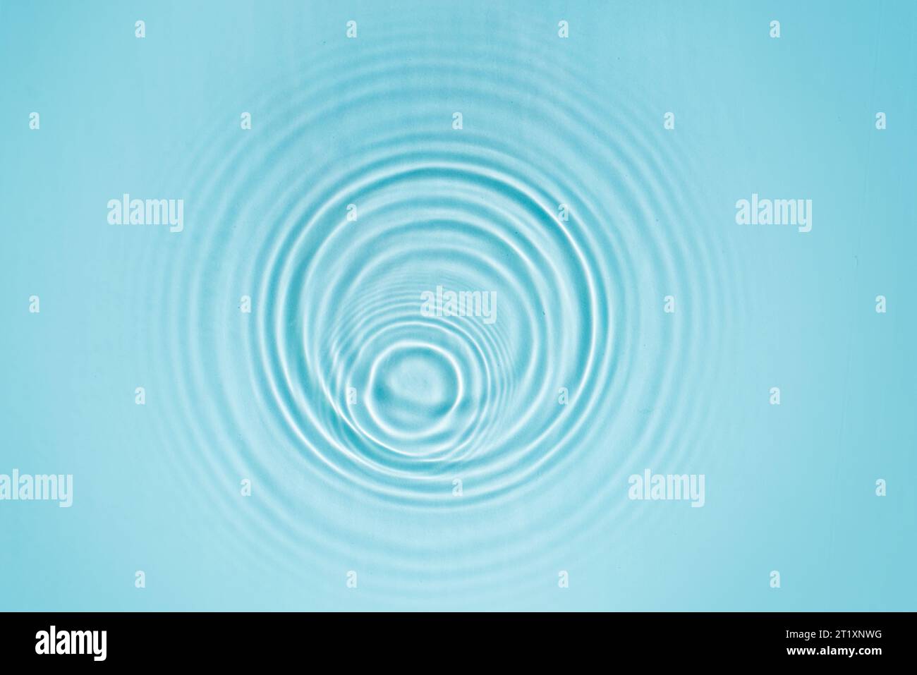 Raindrops on the surface of the water. Swimming pool water background with drops and ripples ...