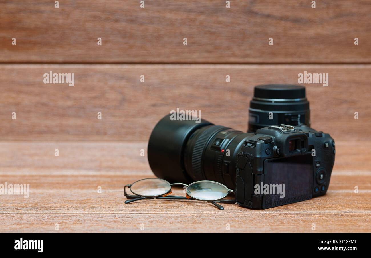 digital camera and lens on wooden floor Stock Photo - Alamy