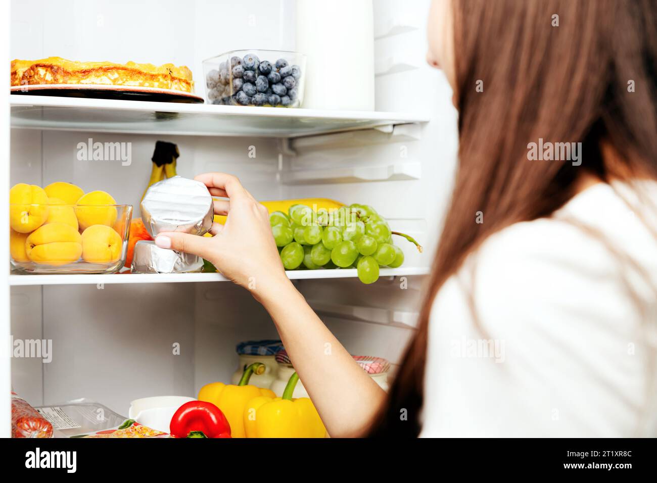 Woman picking up yogurt hi-res stock photography and images - Alamy