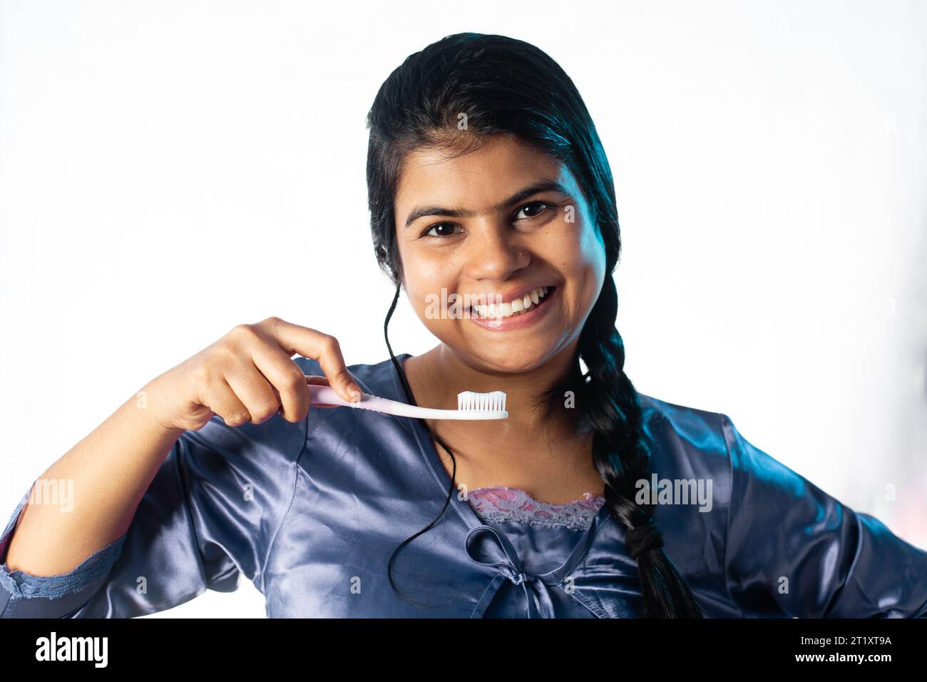 An Indian woman female girl brushing teeth on white background with ...