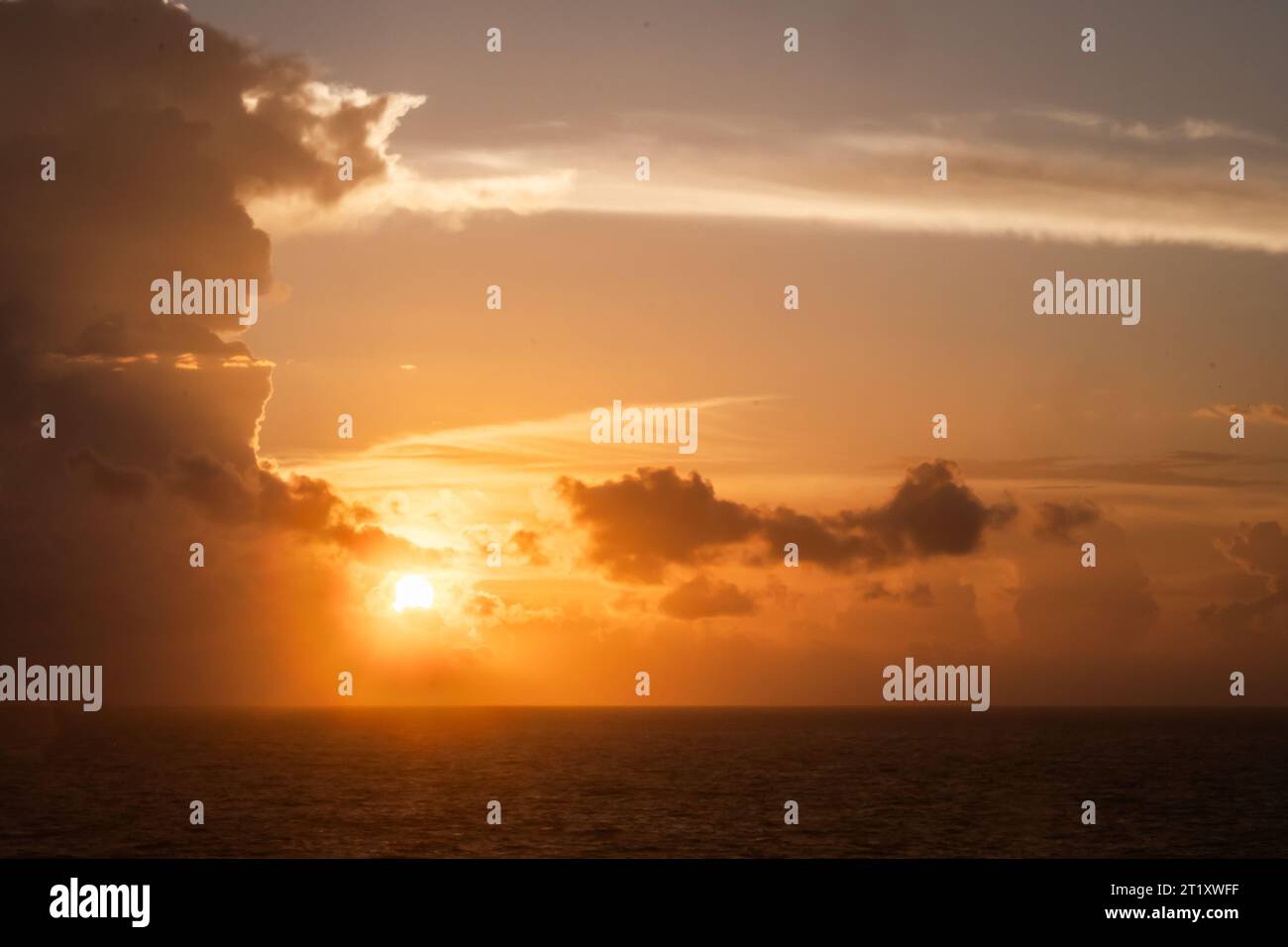 Dramatic clouds at sunrise/sunset sky over the horizon of the Caribbean ...