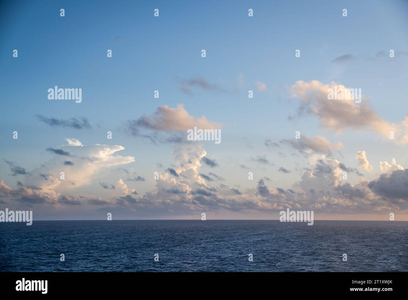 Dramatic clouds at sunrise/sunset sky over the horizon of the Caribbean ...