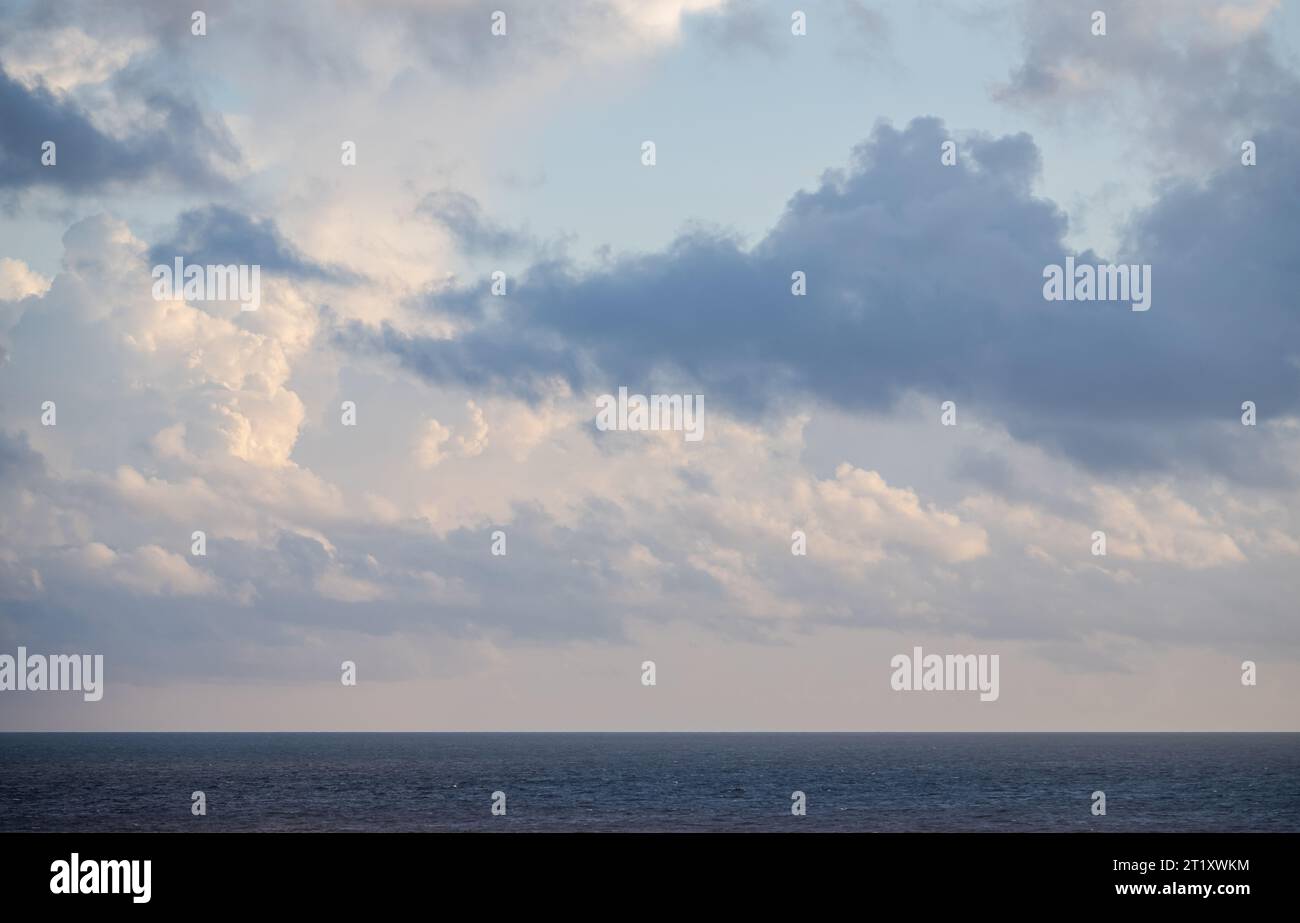 Dramatic clouds at sunrise/sunset sky over the horizon of the Caribbean ...