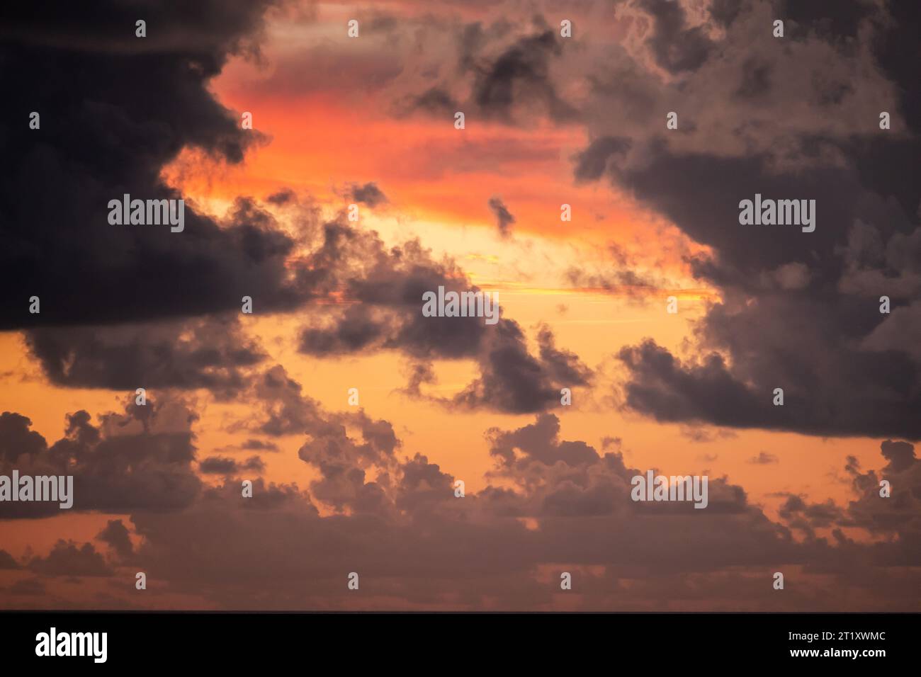 Dramatic clouds at sunrise/sunset sky over the horizon of the Caribbean ...