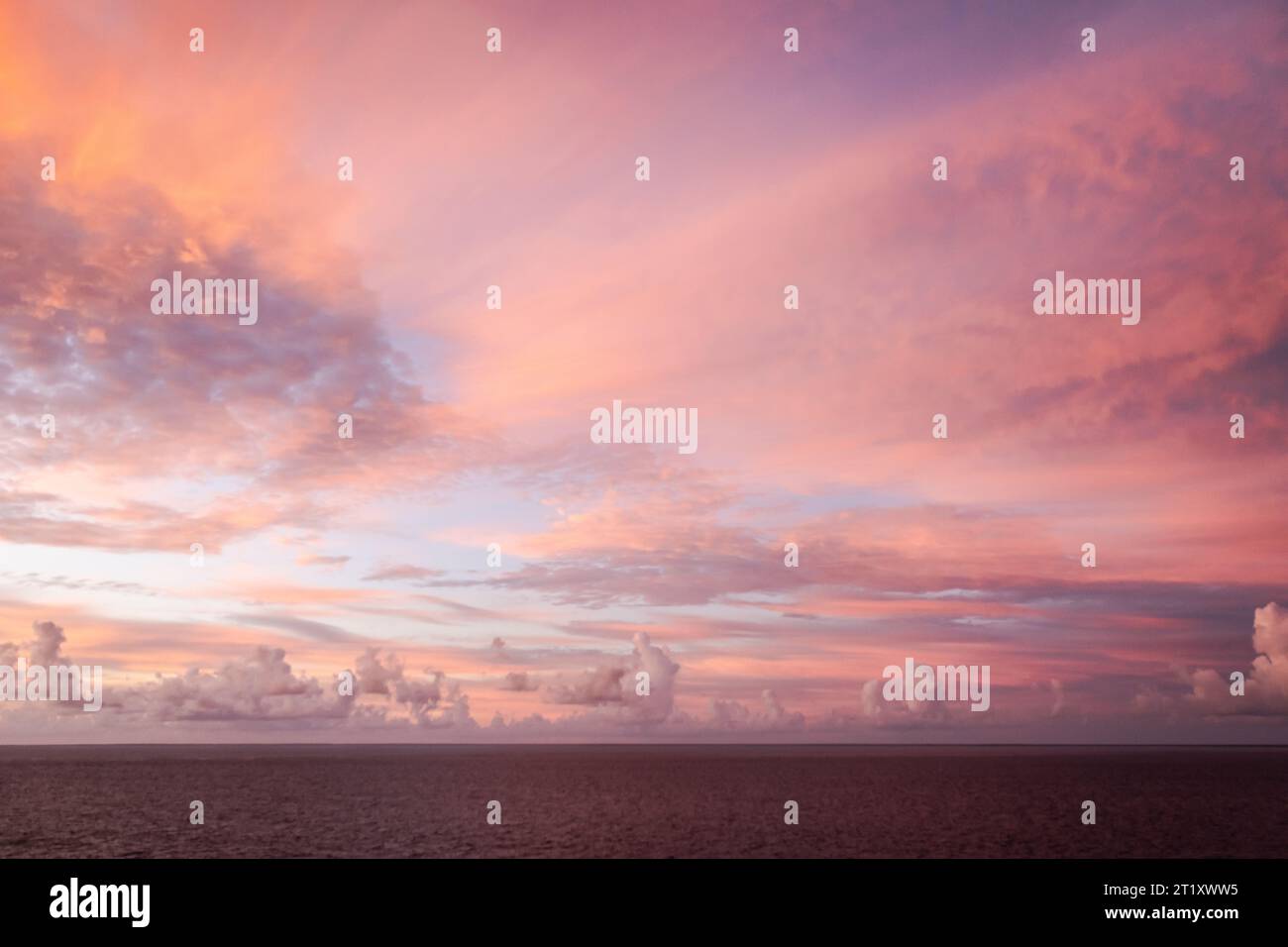 Dramatic clouds at sunrise/sunset sky over the horizon of the Caribbean ...