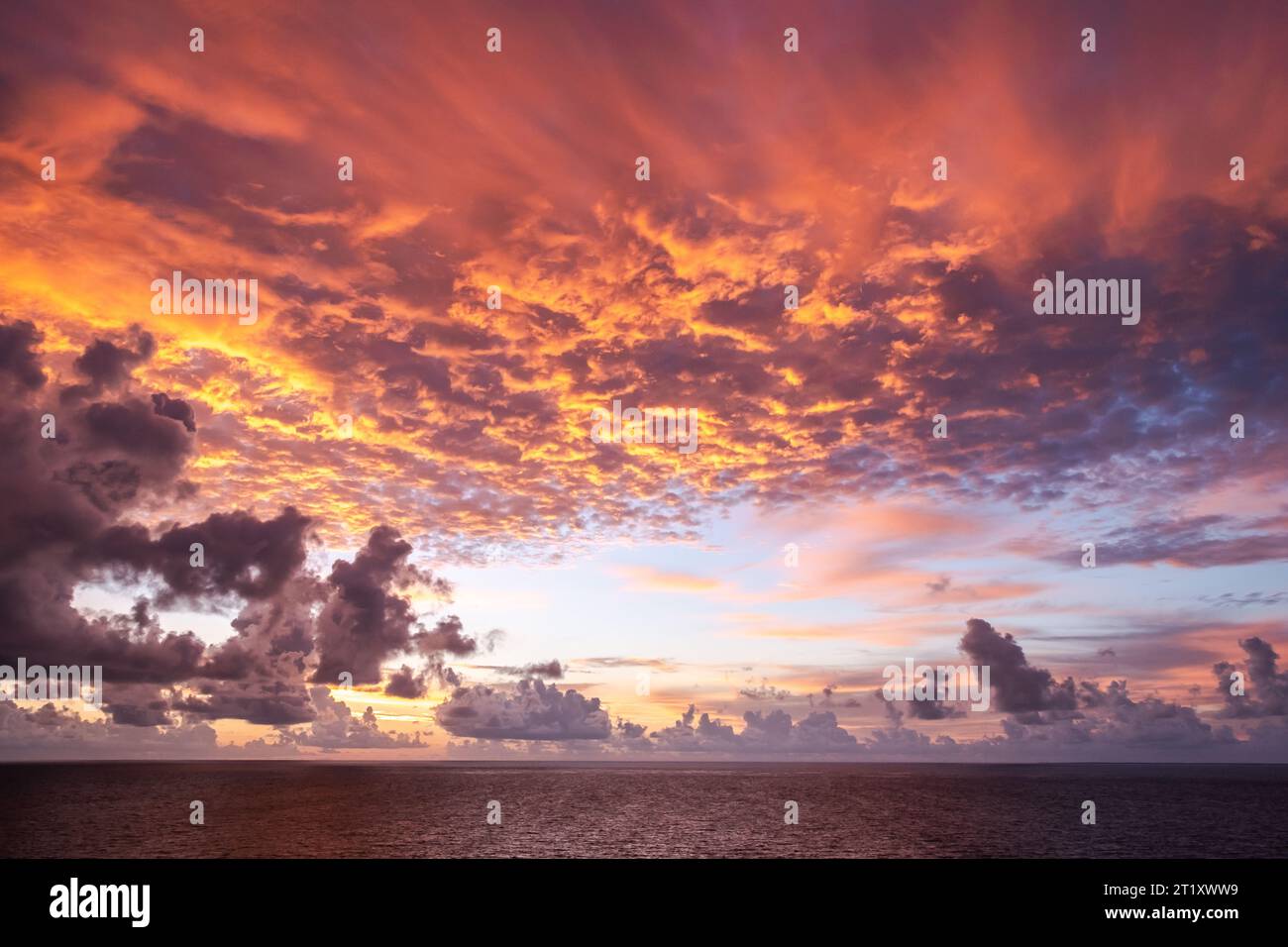 Dramatic clouds at sunrise/sunset sky over the horizon of the Caribbean ...