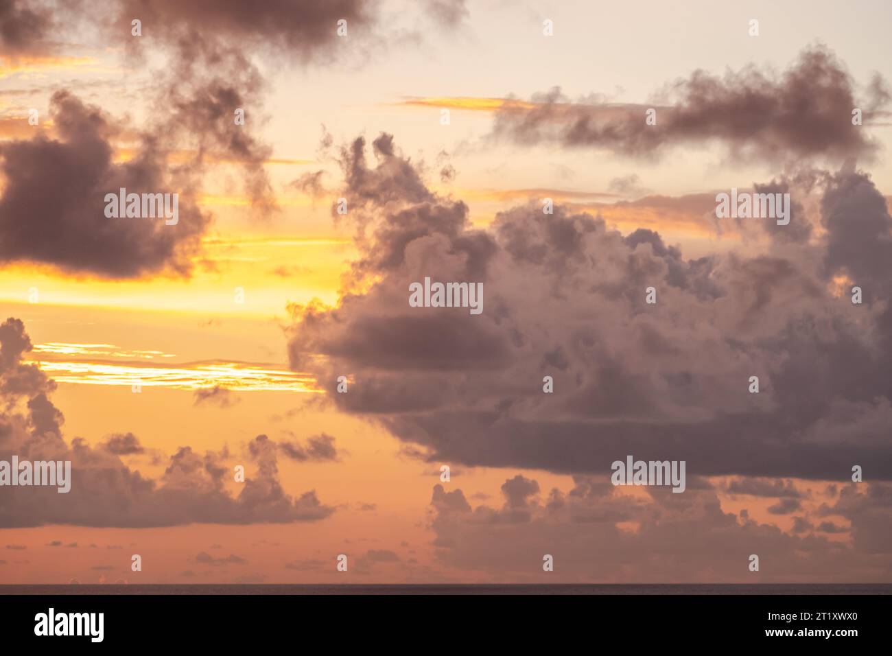 Dramatic clouds at sunrise/sunset sky over the horizon of the Caribbean ...