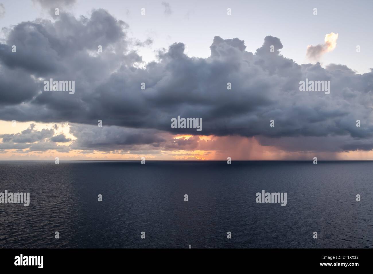 Dramatic clouds at sunrise/sunset sky over the horizon of the Caribbean ...