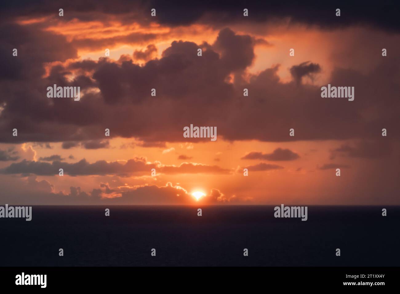 Dramatic clouds at sunrise/sunset sky over the horizon of the Caribbean ...