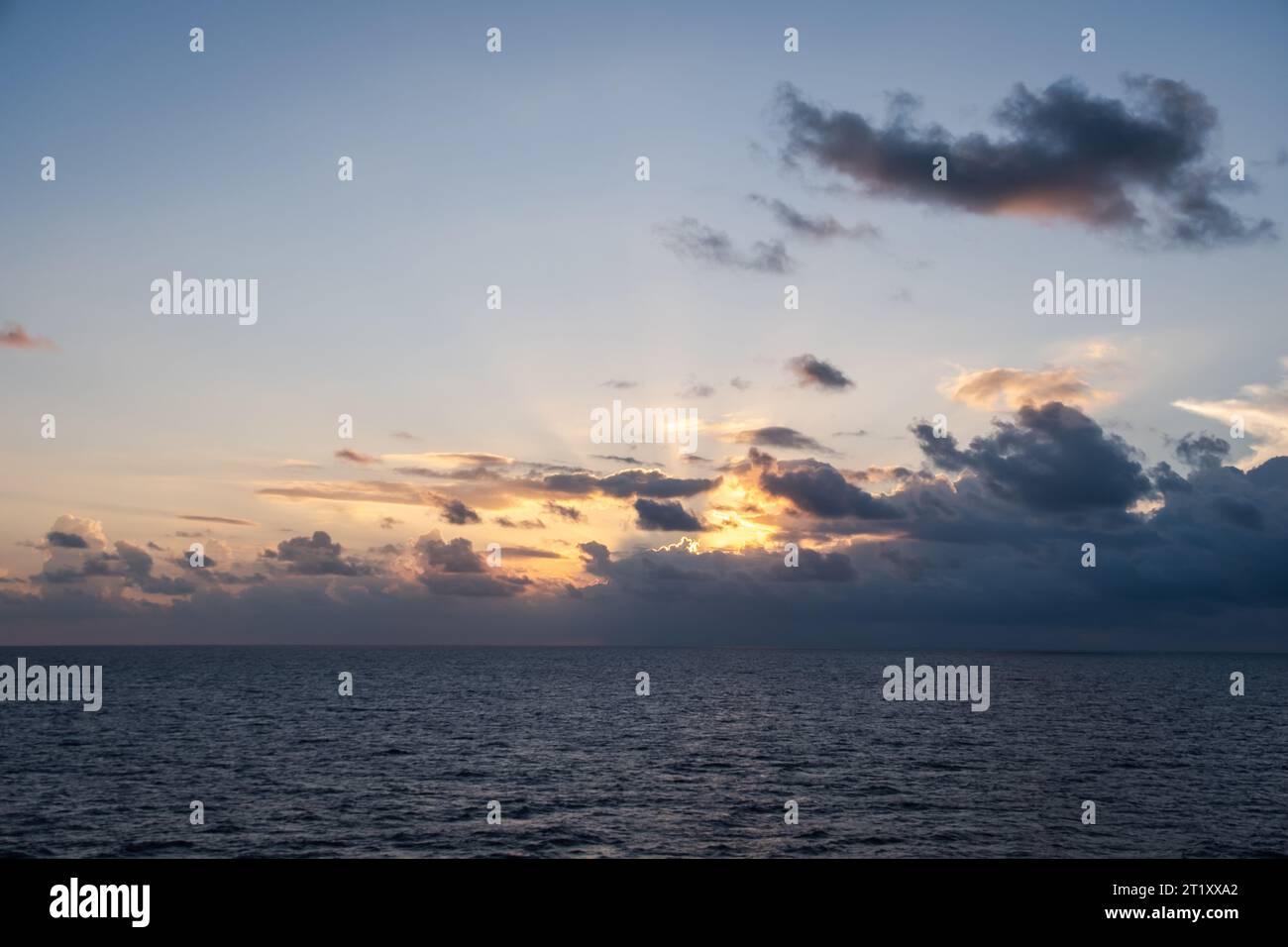 Dramatic clouds at sunrise/sunset sky over the horizon of the Caribbean ...