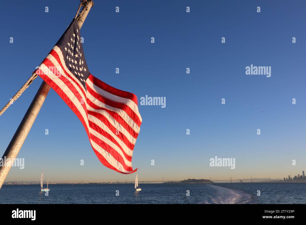 American Flag flying against sky. Imaged captured at the back of a ...