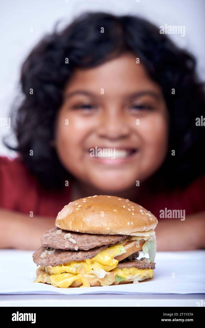 Happy smiling girl is about to eat a hamburger. fast food on a white ...