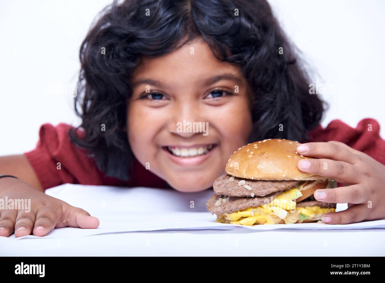 Happy smiling girl is about to eat a hamburger. fast food on a white ...