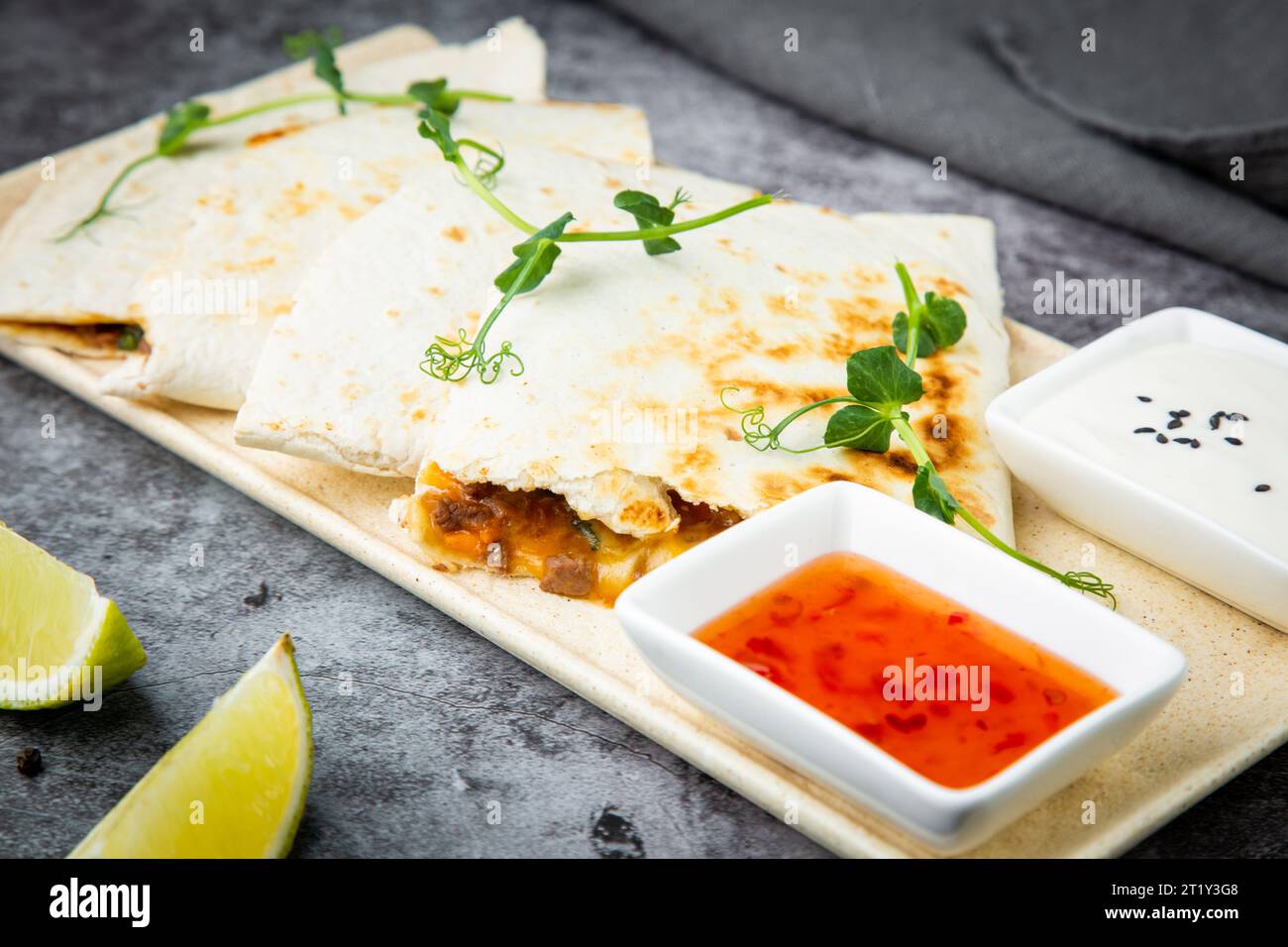 crispy flatbreads stuffed with meat, herbs, lime and two sauces, side ...