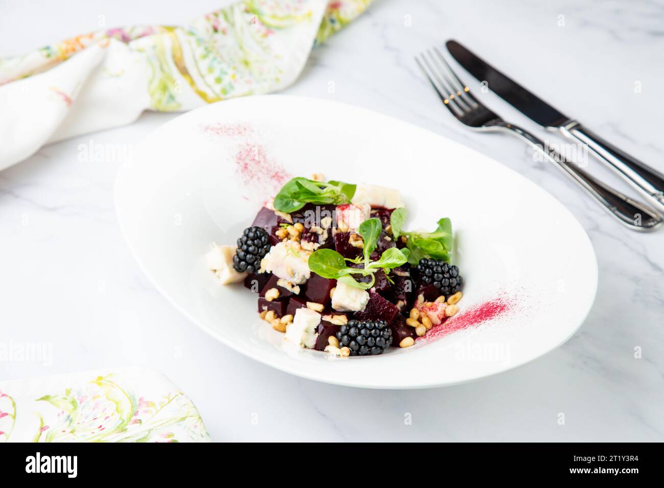 salad of blackberries, beets, seeds and cheese, side view on a white ...