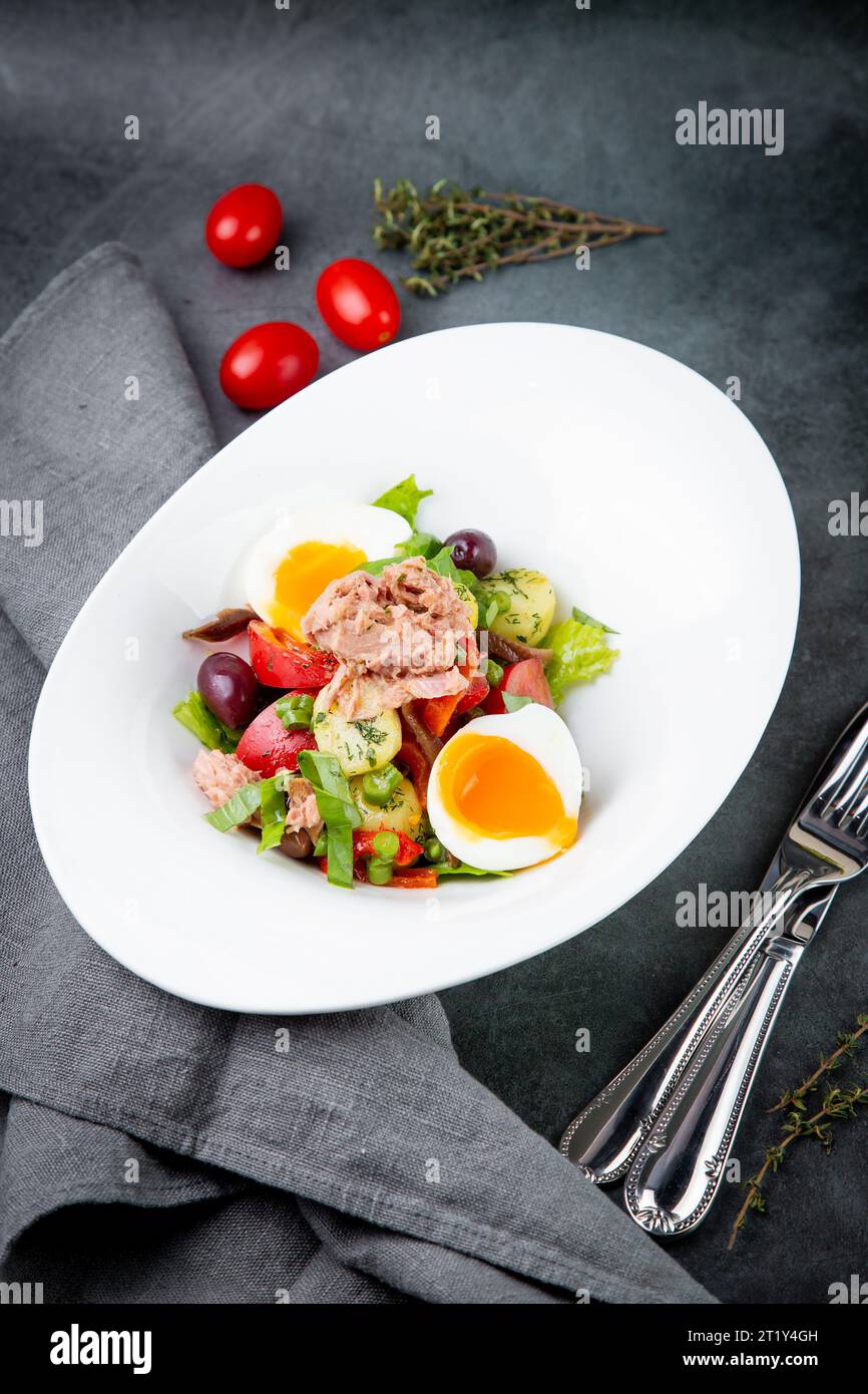salad with soft-boiled egg, tuna, green onions, boiled potatoes, side ...